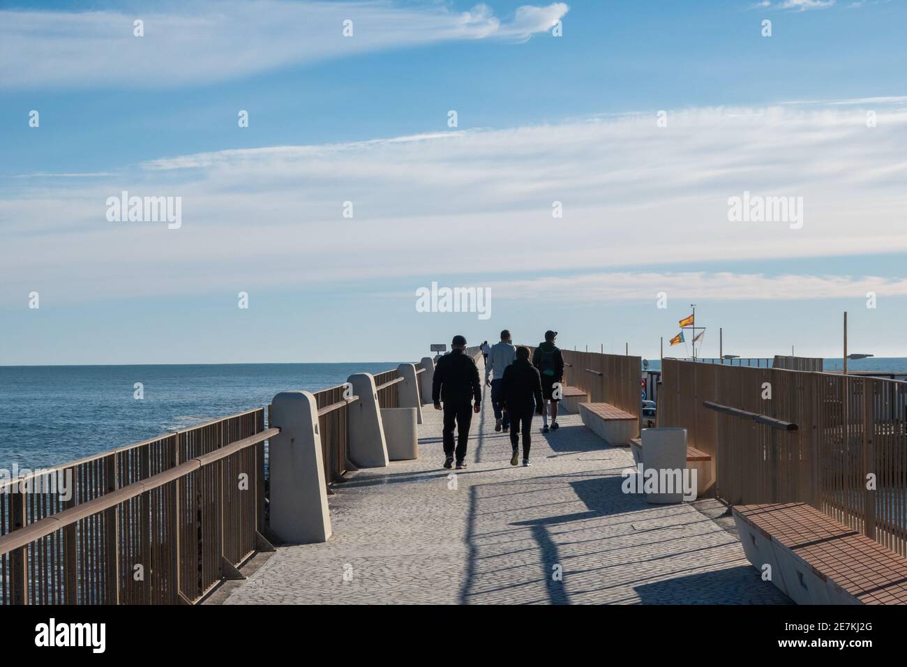 Beautiful view of people walking along the harbor promenade Stock Photo ...