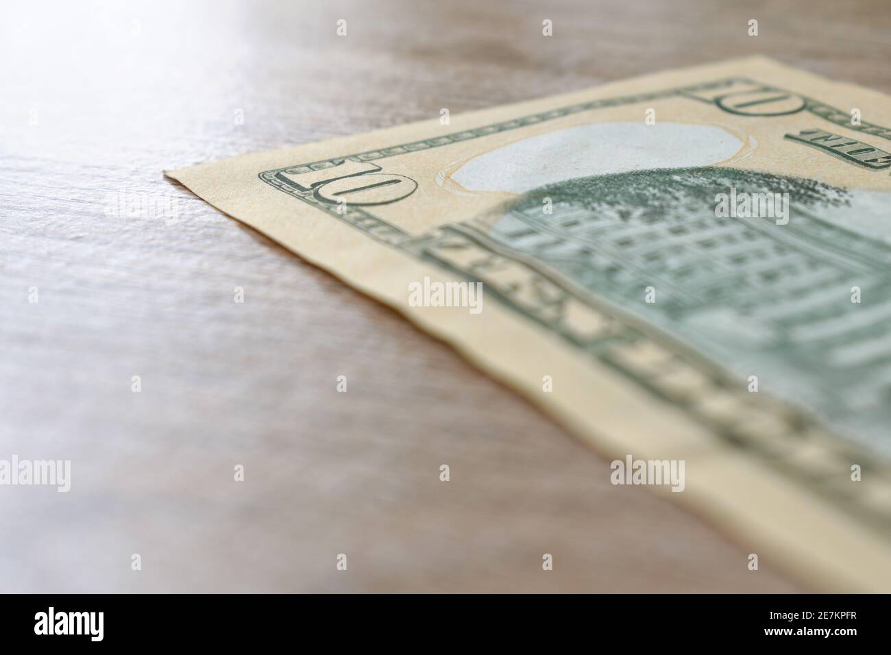 ten US dollar banknote with sunlight background on wooden table Stock ...