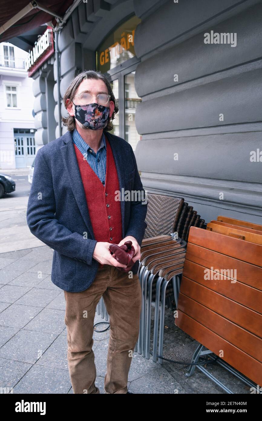 handsome man in his 50s with face mask in front of closed store Stock ...