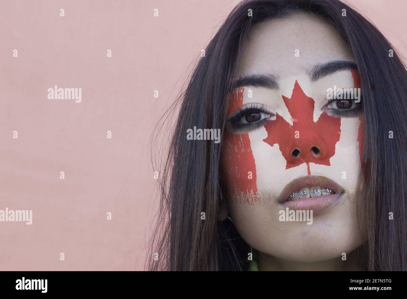 Flag of Canada painted on a face of a young female Stock Photo - Alamy