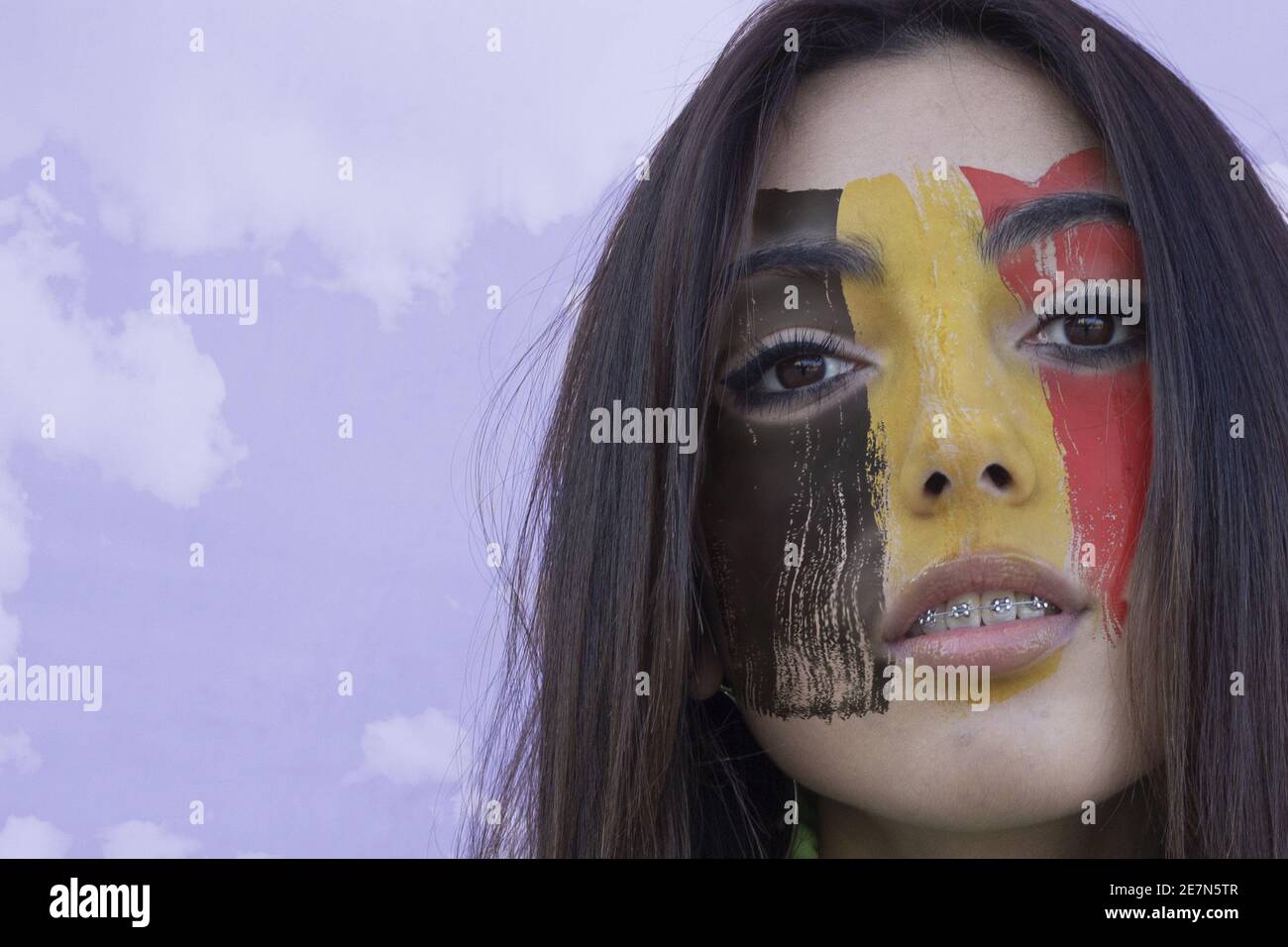 Flag of Belgium painted on a face of a young female Stock Photo - Alamy