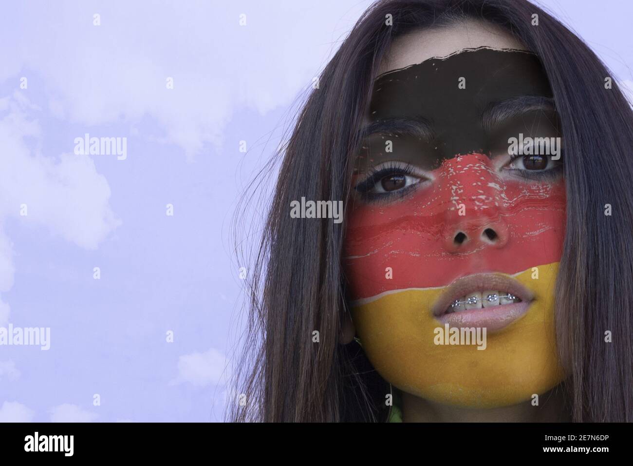 Flag of Germany painted on a face of a young female Stock Photo - Alamy
