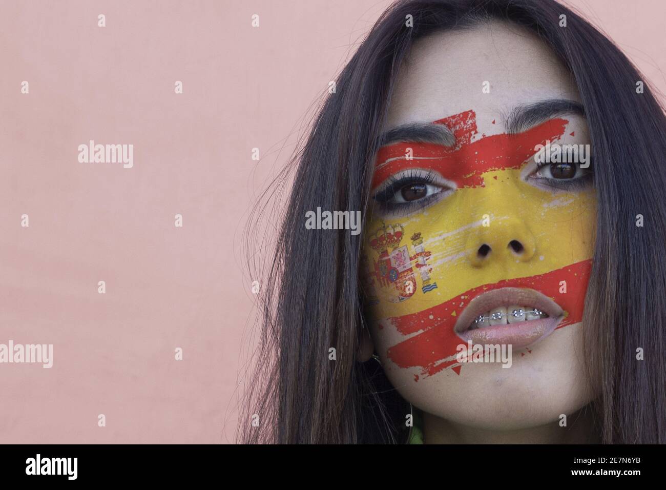 Flag of Spain painted on a face of a young female Stock Photo - Alamy