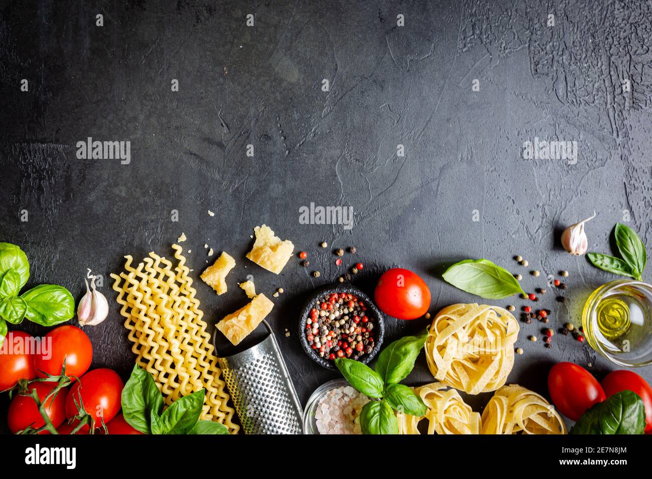 Pasta background. Several types of dry pasta with vegetables and herbs ...