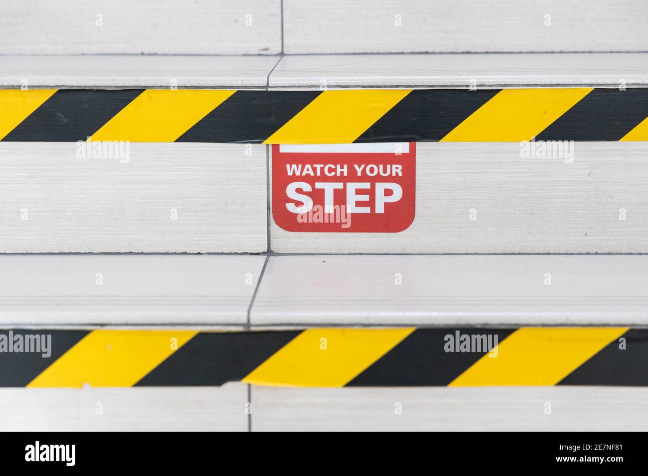 Watch Your Step word signage with yellow black strip on stair steps ...