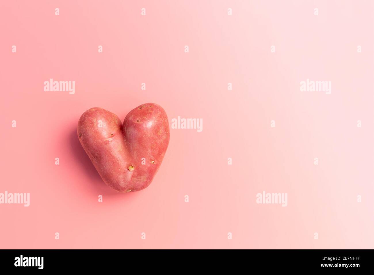 unusually heart shape potato on pink background, food shape Stock Photo ...