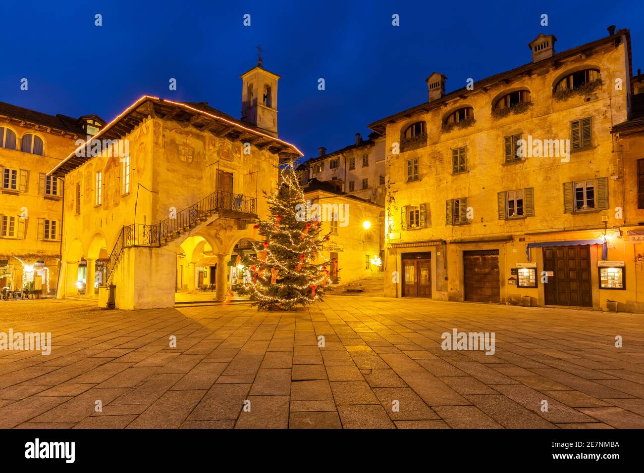 The golden lights of the small town of Orta during blue hour. Orta San ...