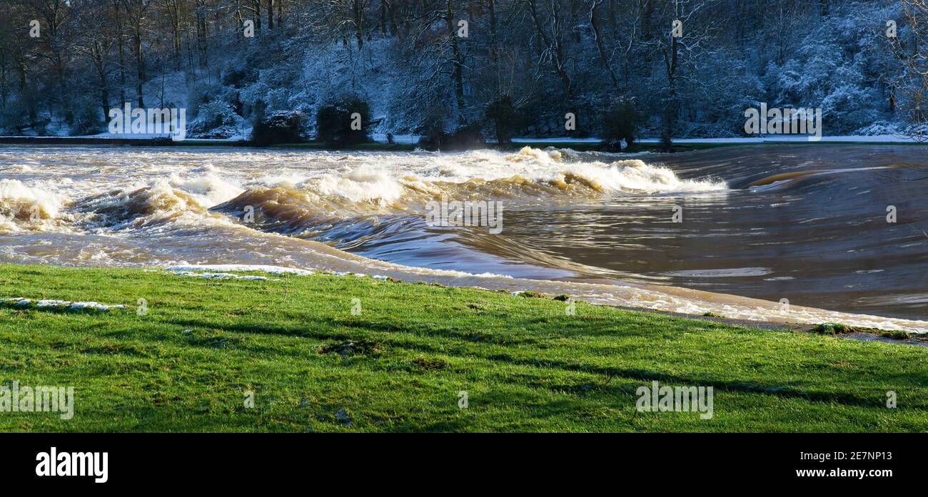Turbulent waters flowing over a flooded river weir near Long Eaton ...