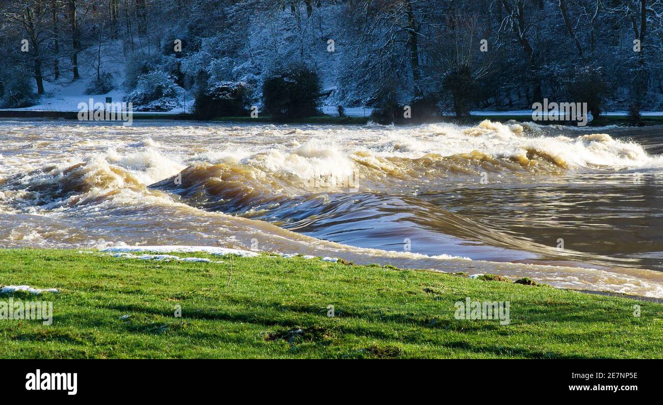 Turbulent waters flowing over a flooded river weir near Long Eaton ...