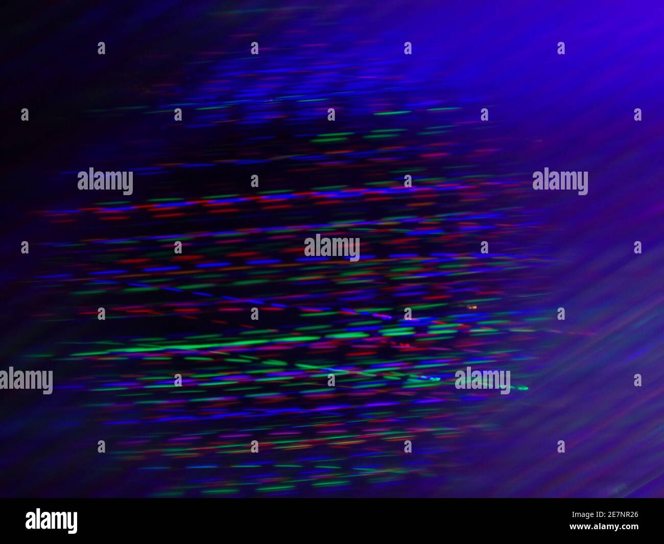 Colorful progressive rhythmic light trails on a black and blue ...