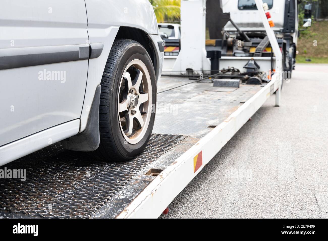 Cable attached to broken down car being pulled onto tow truck Stock ...