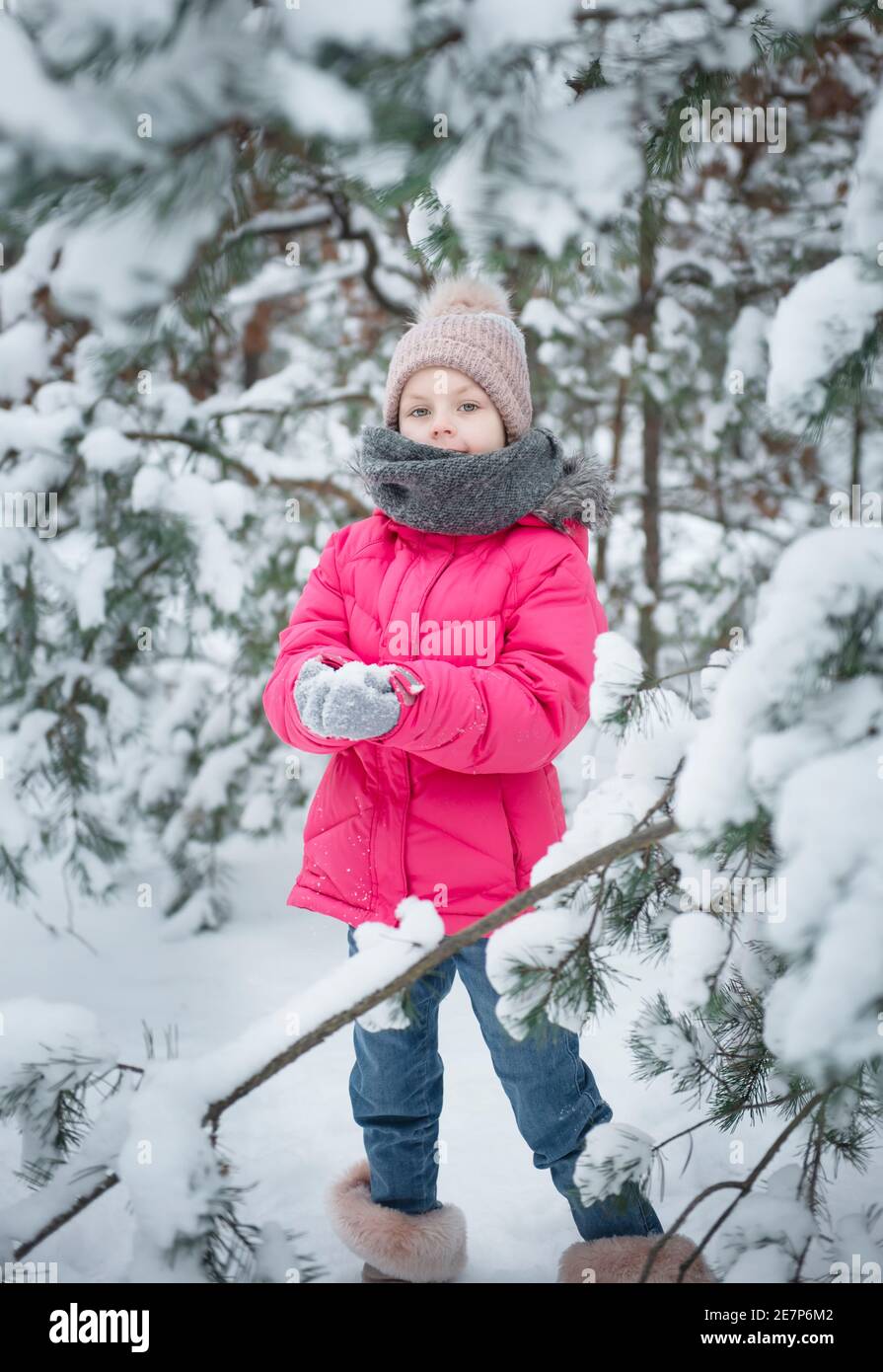 Child in winter. A little girl, playing in the winter outside. A ...