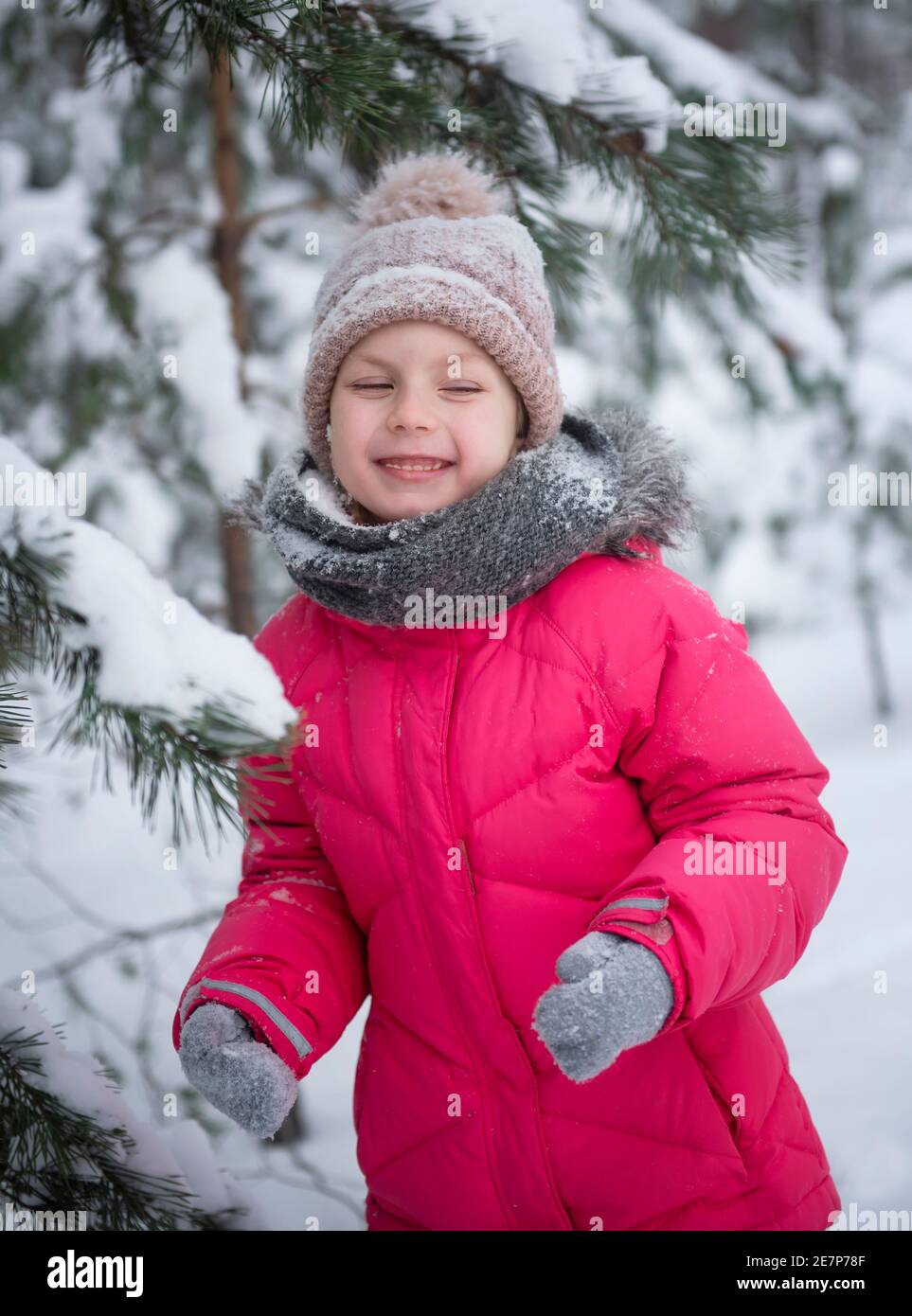 Child in winter. A little girl, playing in the winter outside. A ...