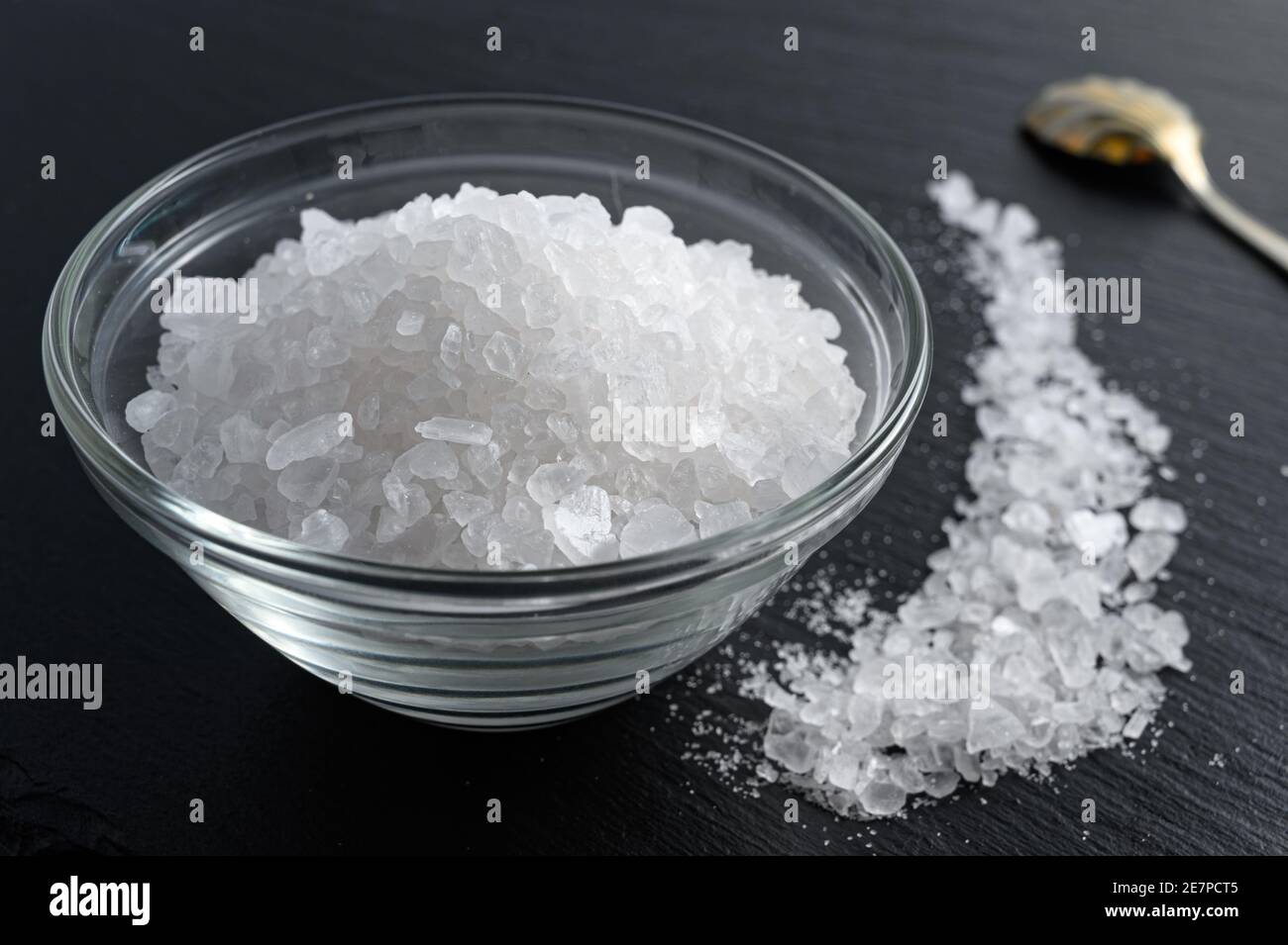 Glass bowl of sea salt on black background Stock Photo - Alamy