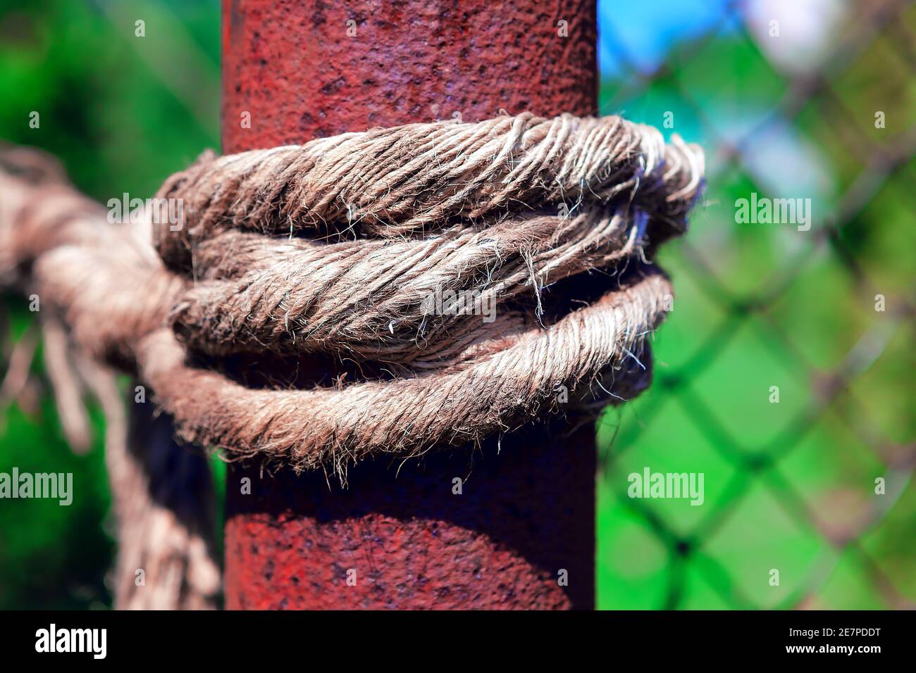 Rope wrapped around a rusty bar , macro image Stock Photo - Alamy
