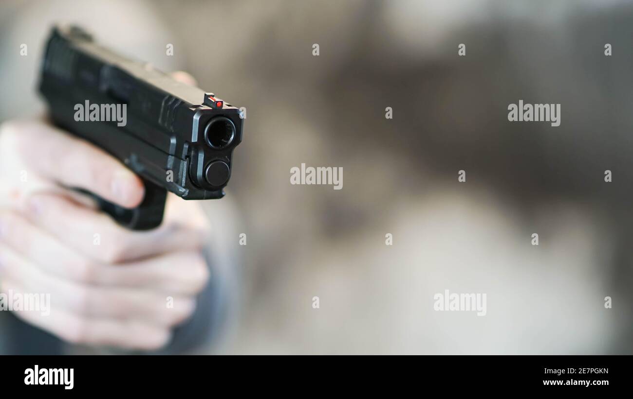 Man holding a pistol hi-res stock photography and images - Alamy