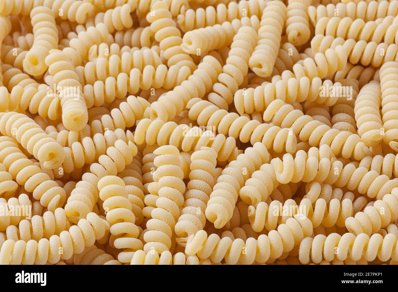 Uncooked fusilli corti bucati pasta background Stock Photo - Alamy