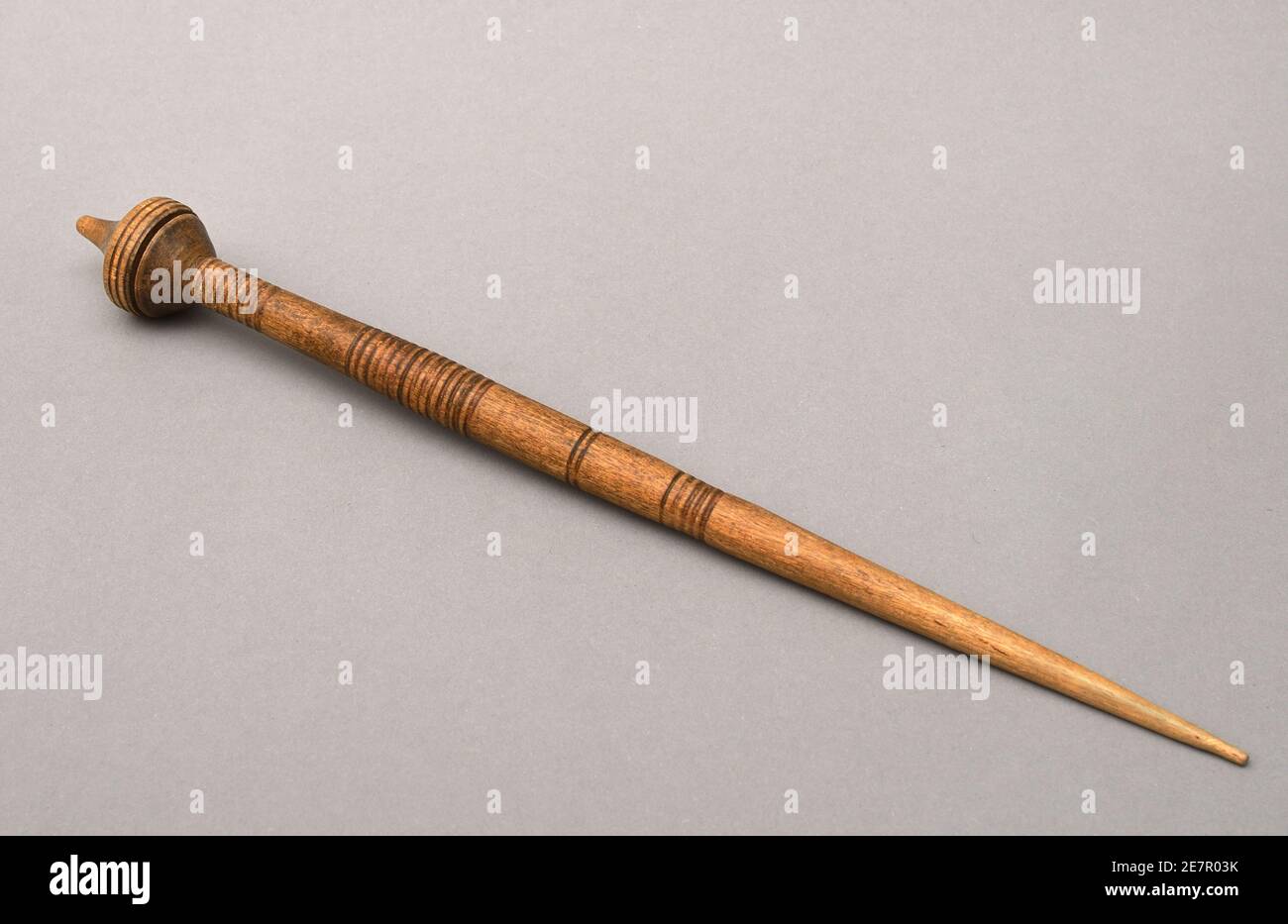 old vintage wooden spindle on gray background Stock Photo - Alamy