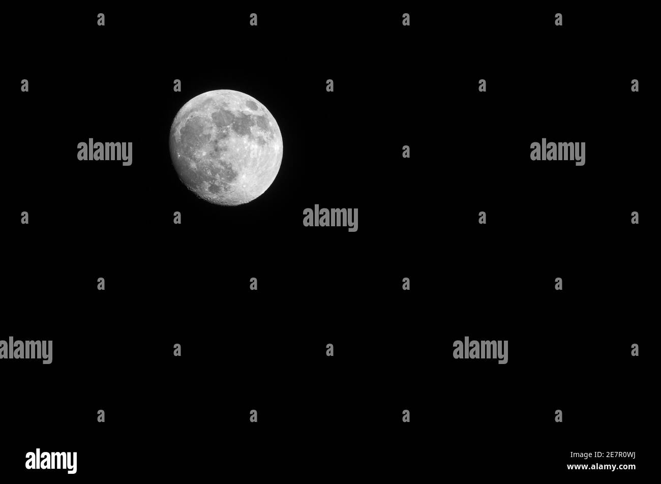 7/8ths almost full moon in great detail against a pure black sky with ...