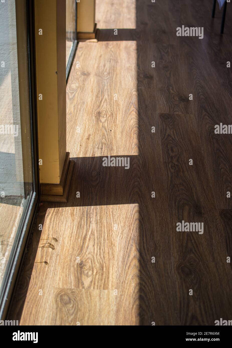 Vertical shot of the sunlight falling on the floor through windows ...
