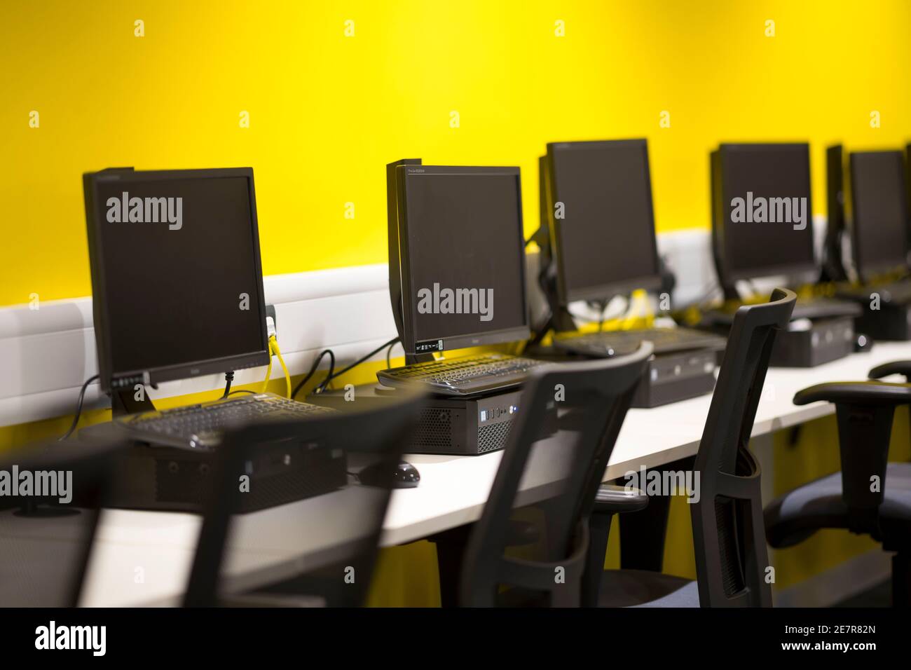 Computer screens lined up in a school classroom Stock Photo - Alamy