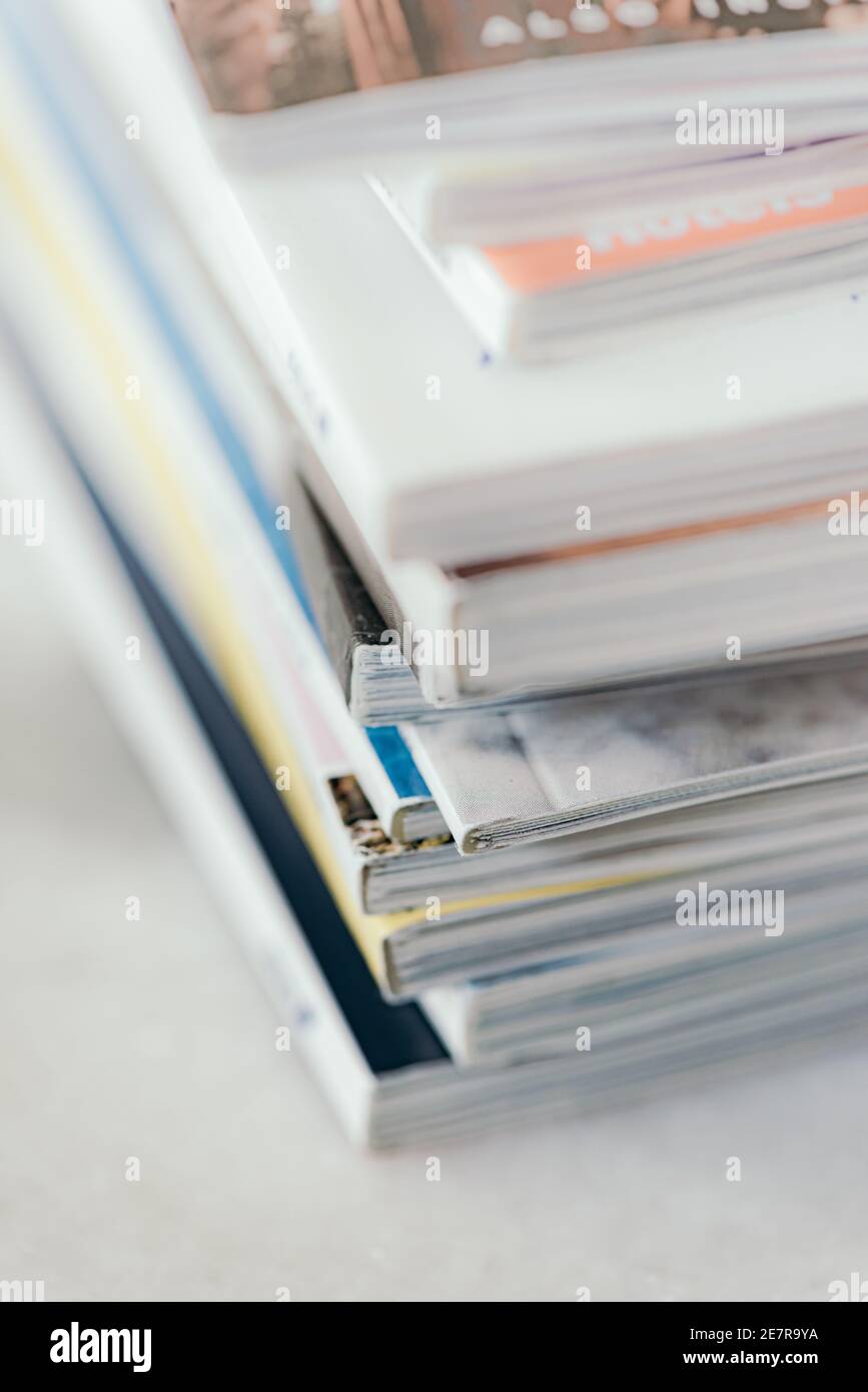 A stack of different thickness magazines seen from an angle to show ...