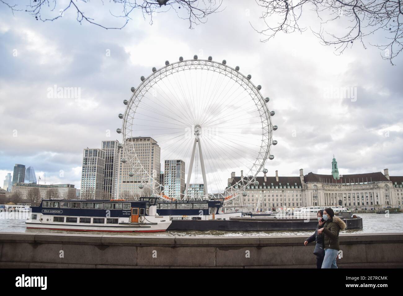 Women wearing face masks walk past the London Eye. (Photo by Vuk Valcic ...