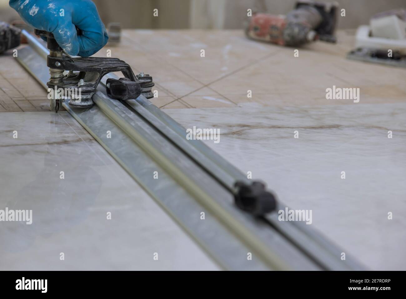 Man working at the cut ceramic tile on the manual tile cutting Stock ...