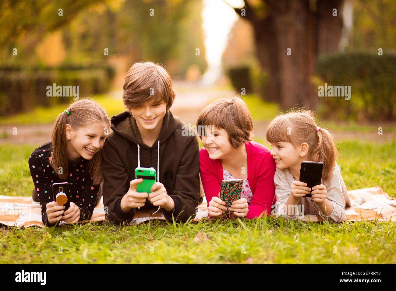 Group of friends girls using mobile phones and chatting together In ...