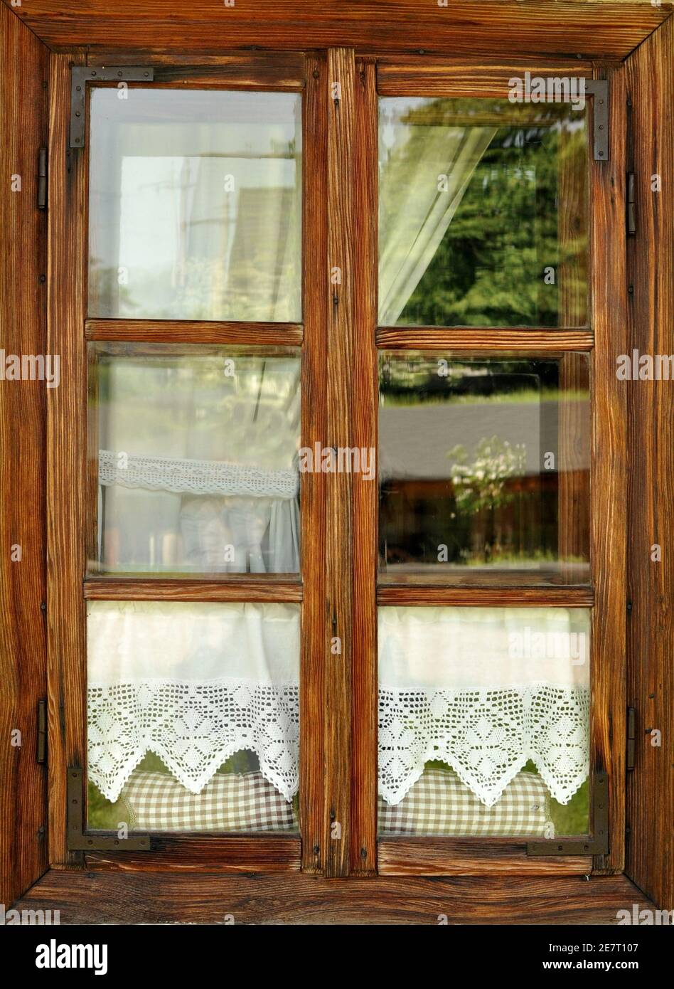 Traditional vintage old brown wooden frame window. Front view, close up ...