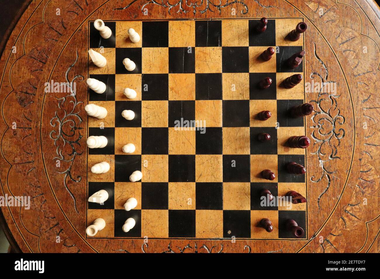 The top view of an old chess set on a purpose build carved chess board ...