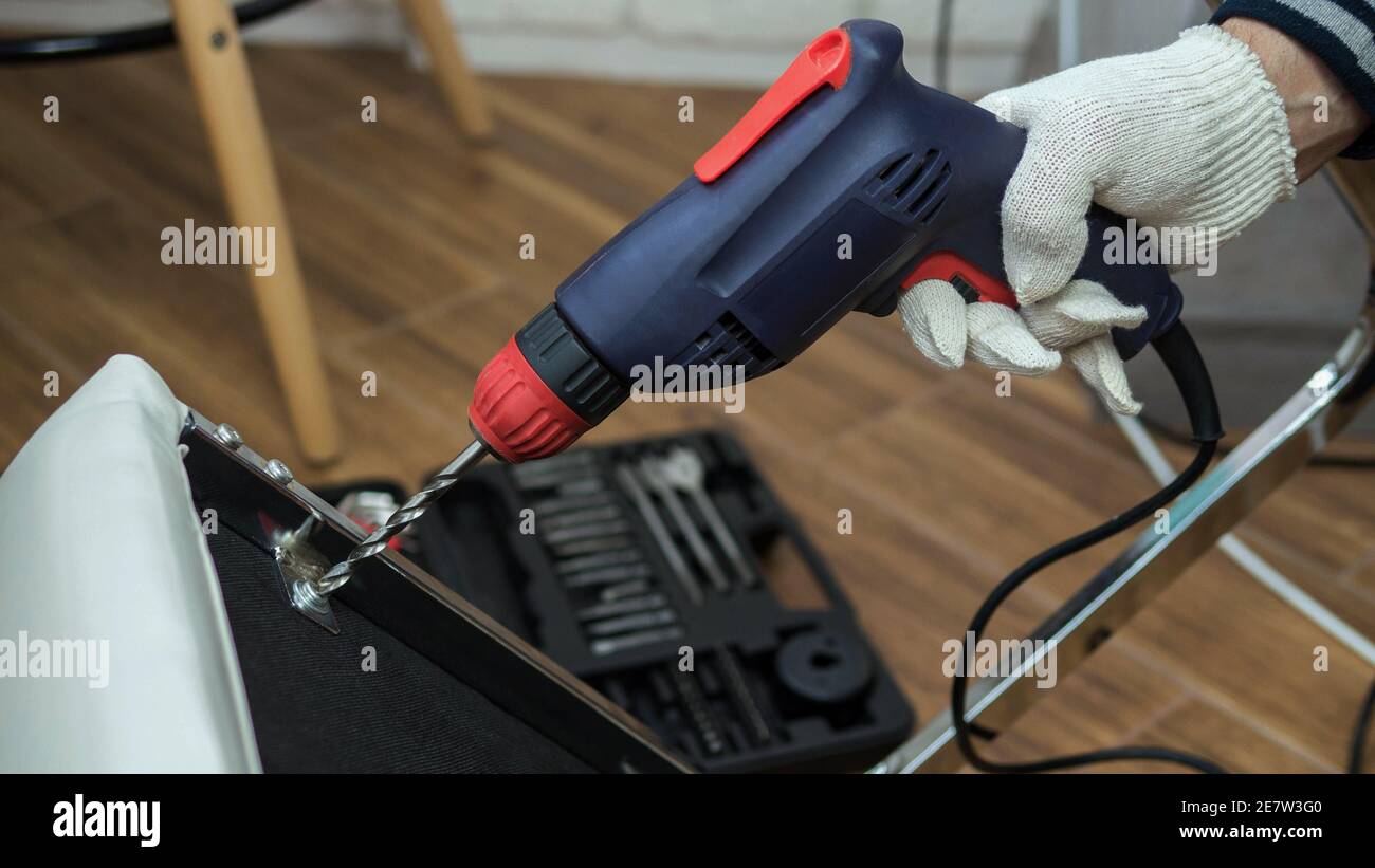 Man worker drills metal electric hi-res stock photography and images ...