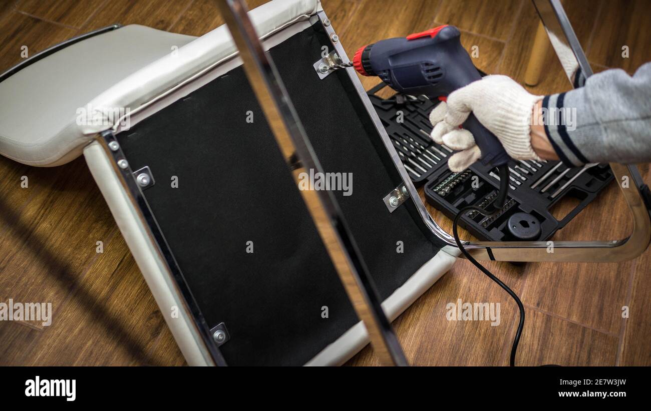 Man using electric drill attach hi-res stock photography and images - Alamy