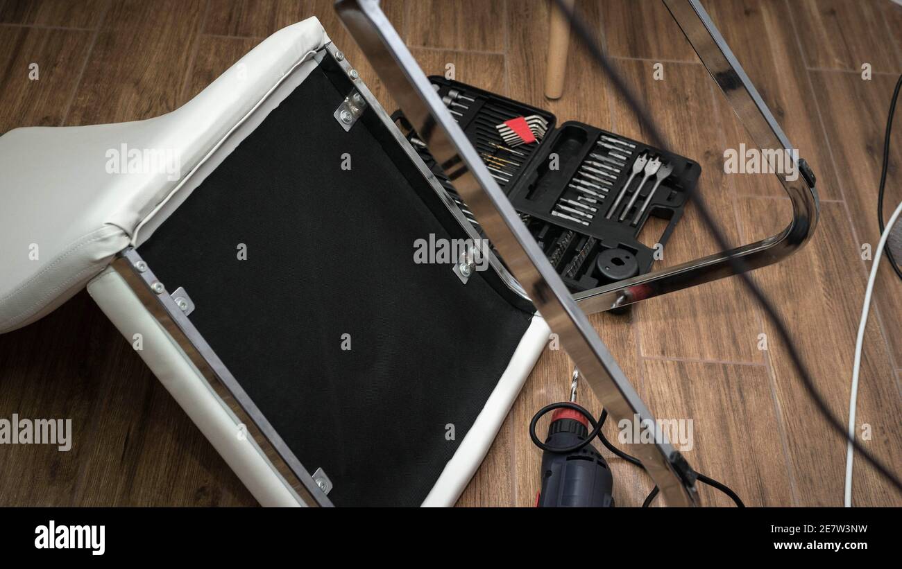 Furniture maker working process, tools with disassembled furniture ...