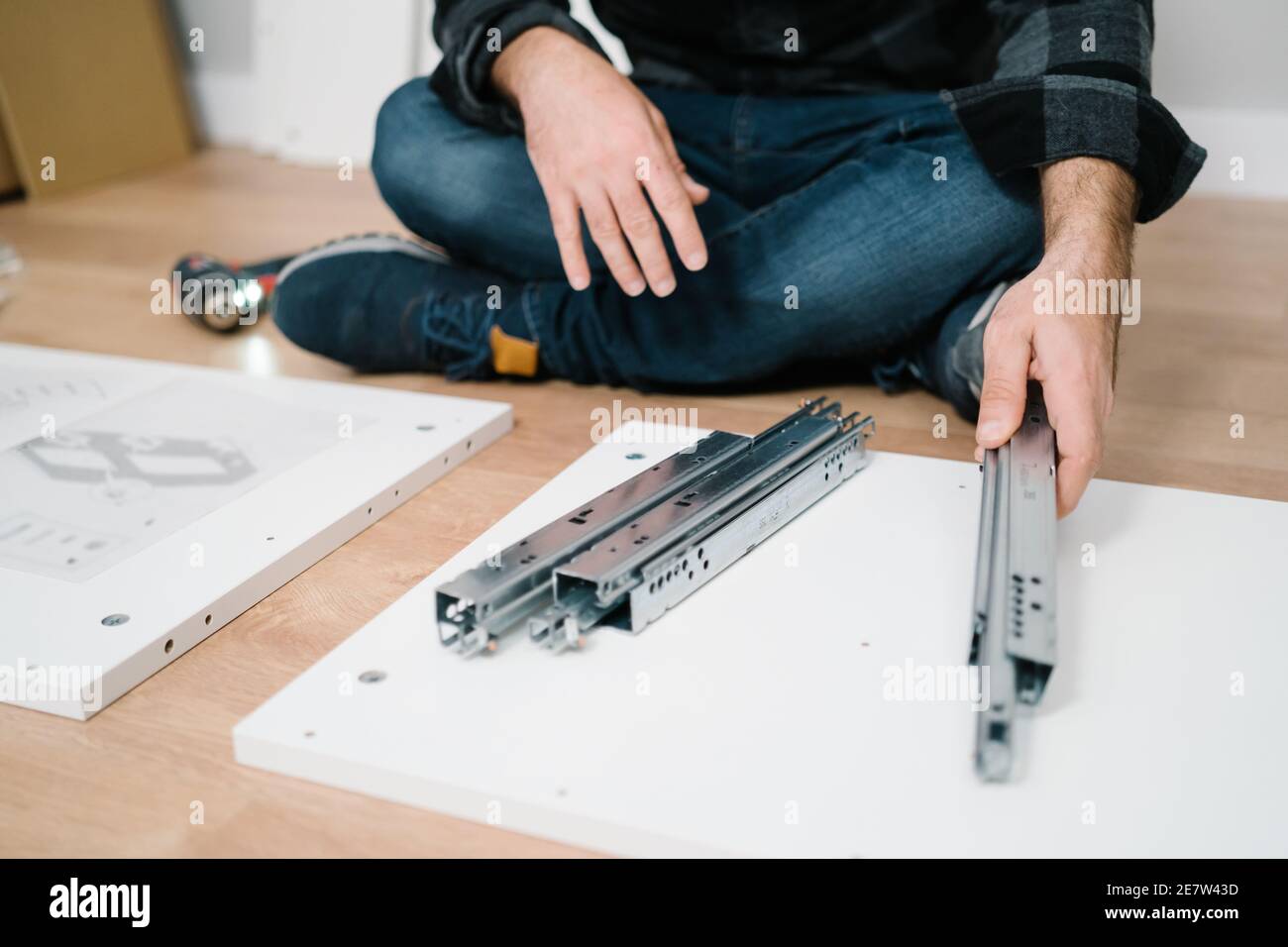 Portrait of man assembling furniture. Do it yourself furniture assembly ...