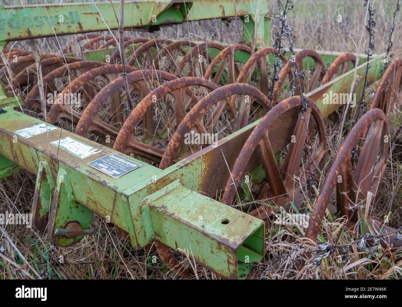 Abandoned Farmer's Furrow Press overgrown with grasses Stock Photo - Alamy