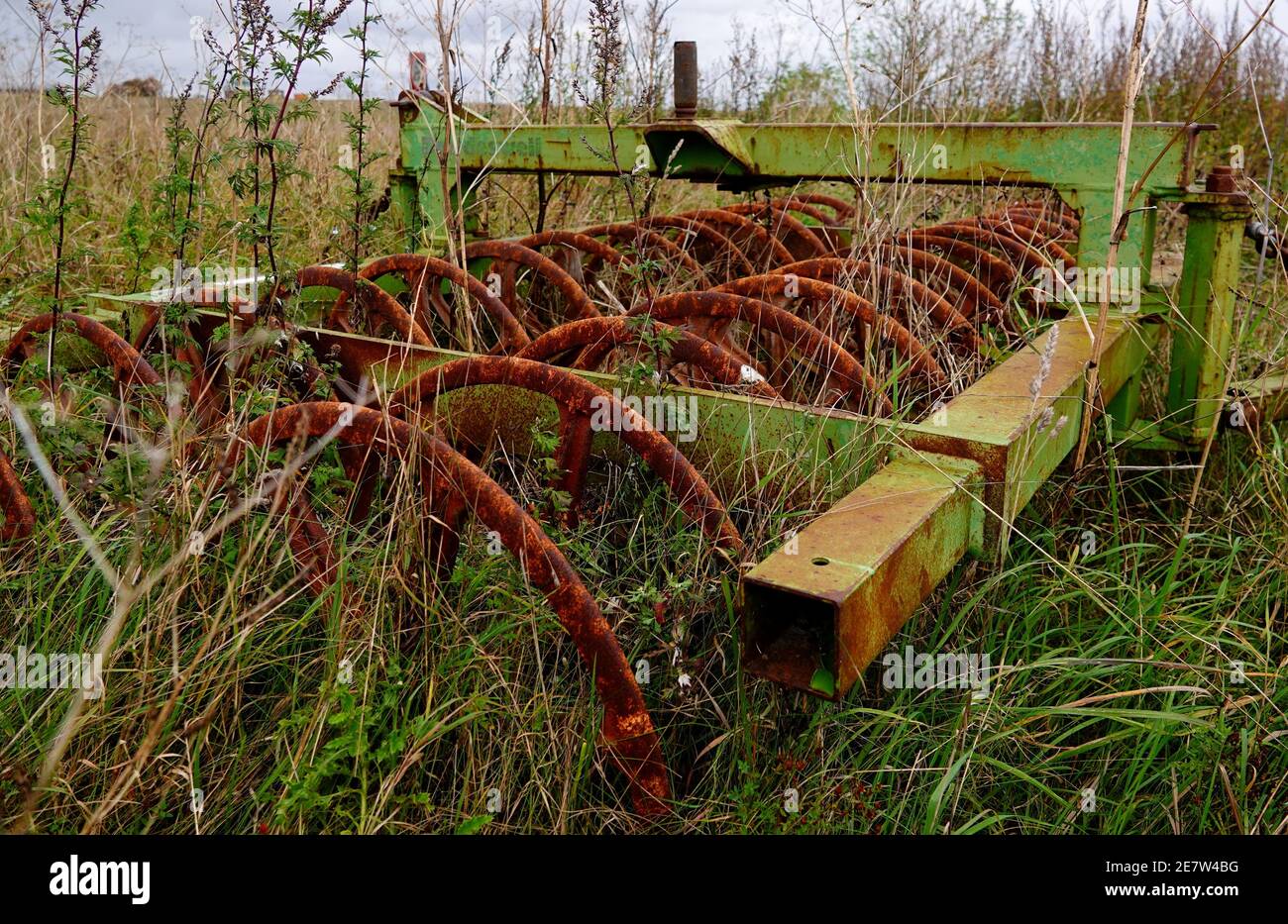 Abandoned Farmer's Furrow Press overgrown with grasses Stock Photo - Alamy