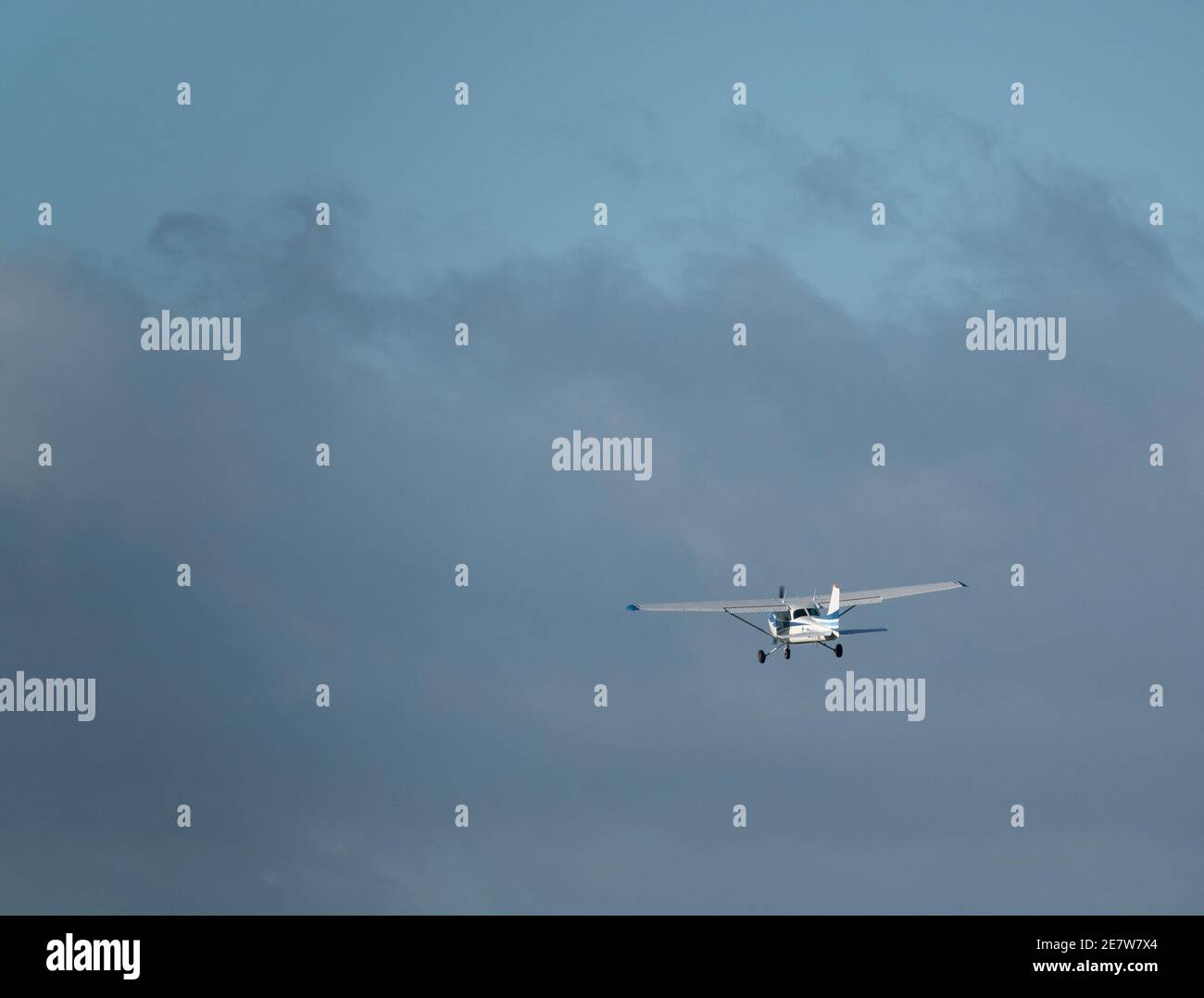 light aircraft heading off towards a blue cloudy sky sunny Stock Photo ...
