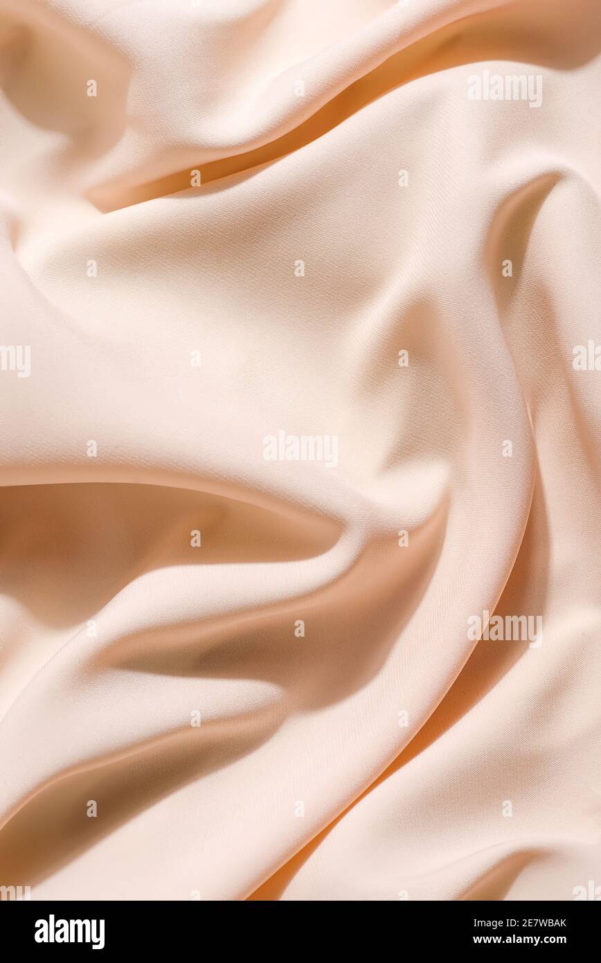 beautiful silk fabric of delicate pastel color, light orange, draped ...