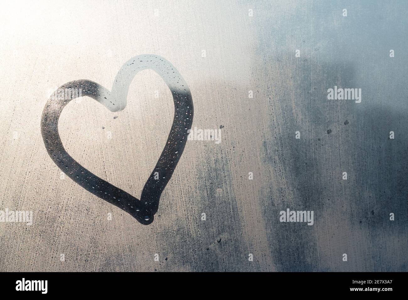 hand drawing heart on frozen window with natural sunlight Stock Photo ...