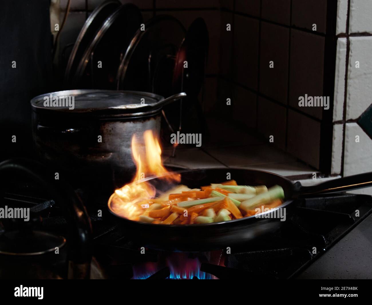 Flambe Chef Cooking in Kitchen. Professional chef flambe style Stock ...