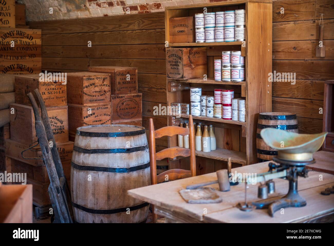Crates labeled "peaches, candles, soap" and cans labeled "baked beans ...