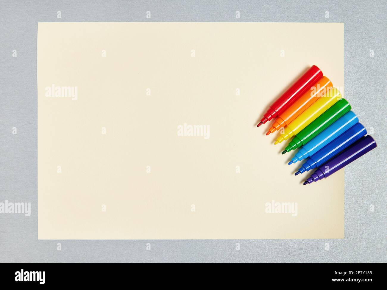Markers rainbow colors on yellow paper for drawing Stock Photo - Alamy