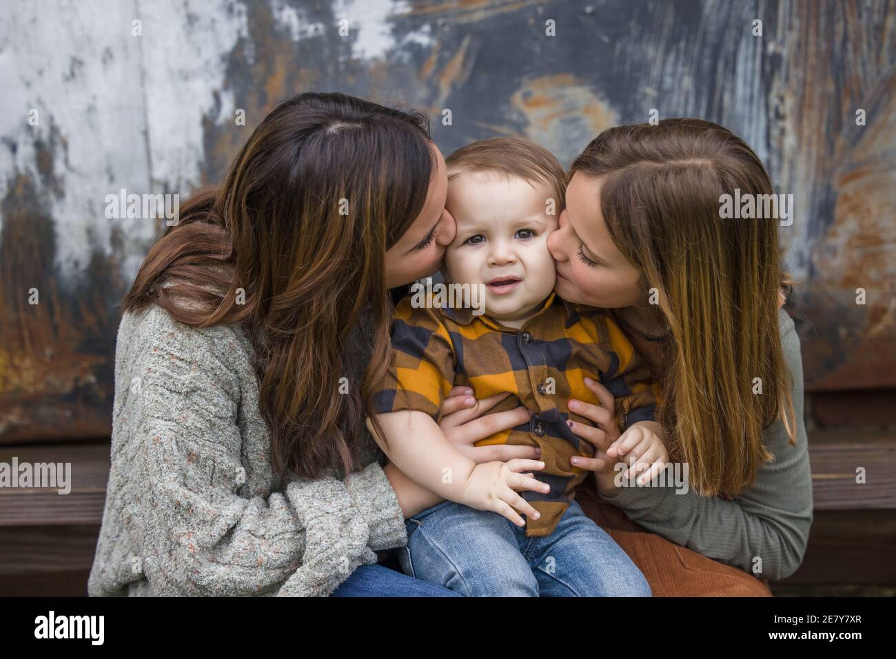 Two sisters and a little baby brother sitting on steps outside for a ...