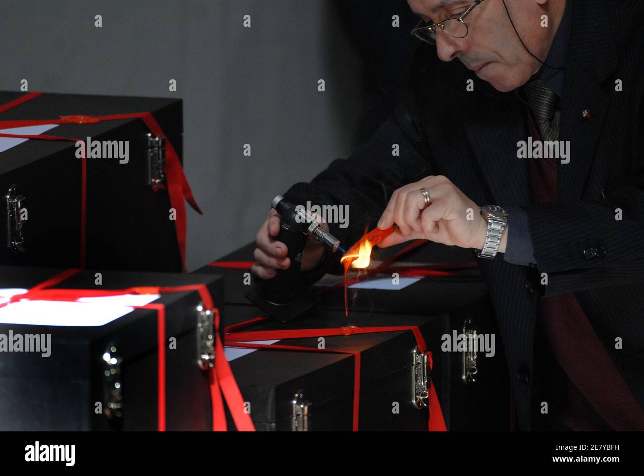 A Vatican worker seals boxes of documents, proof of a purported miracle ...