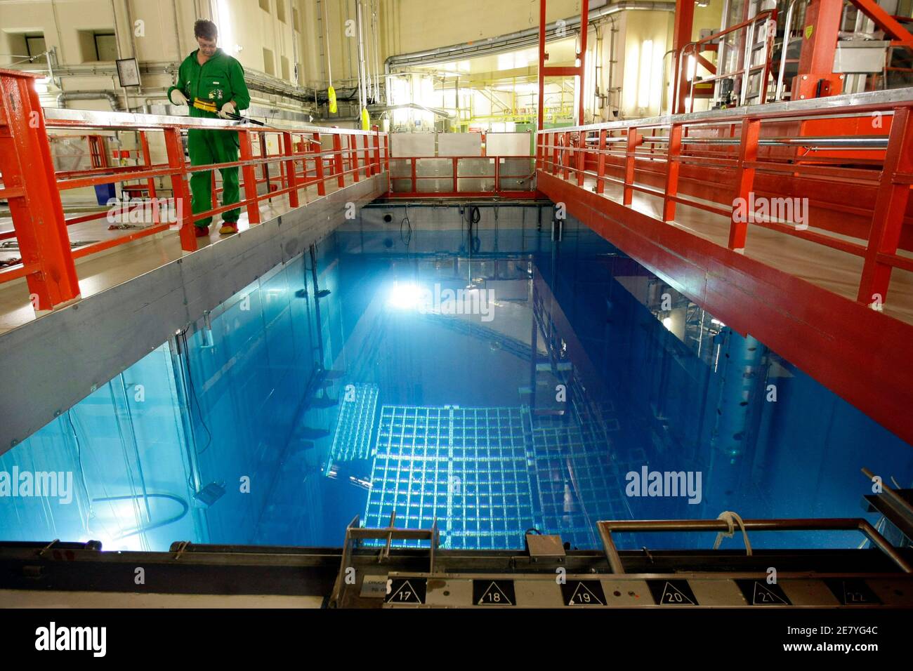 A worker of the radiation protection walks over a bearing basin ...