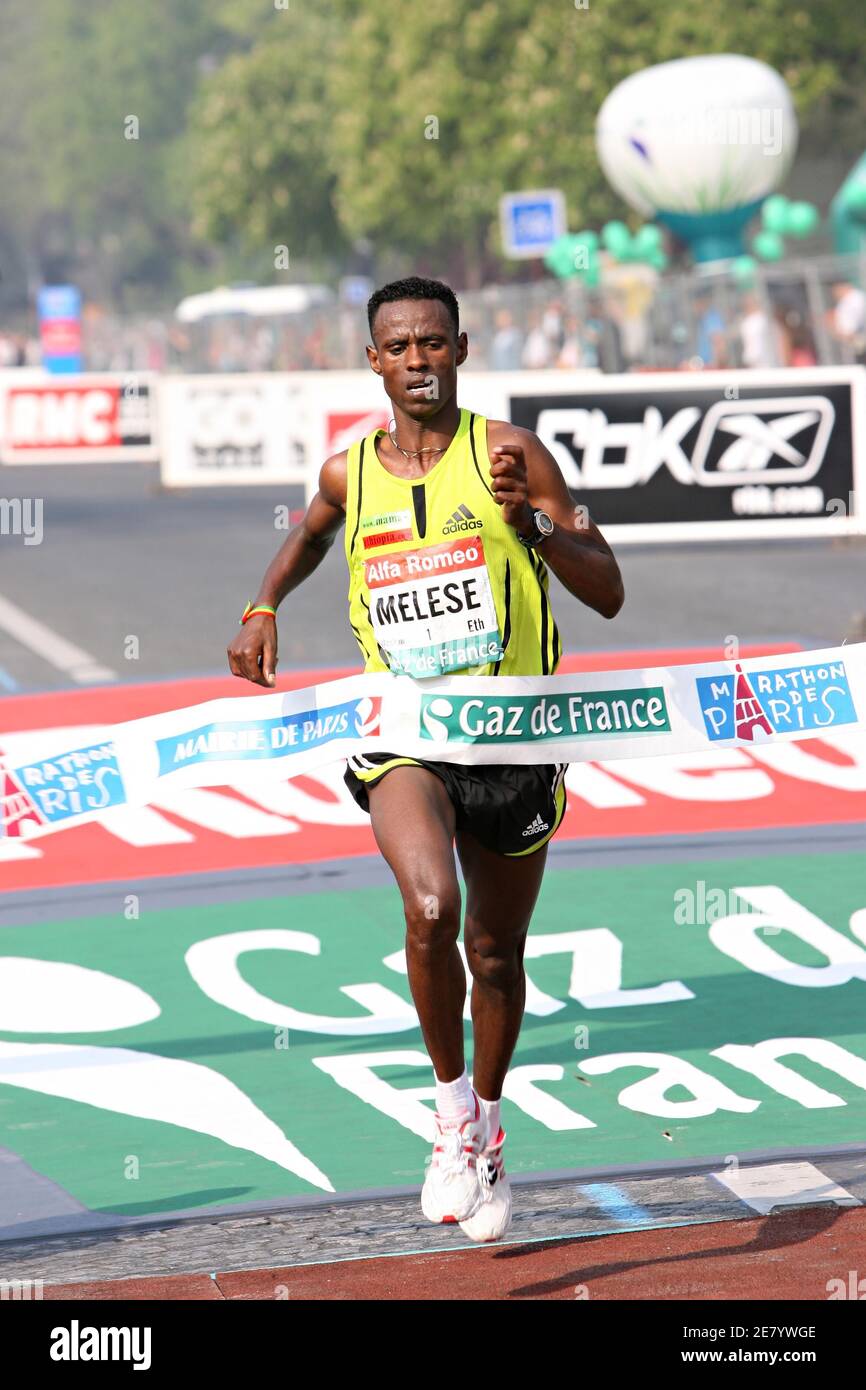 Ethiopia's Gashaw Melese (second) crosses the finish line of the 31th edition of the Paris ...