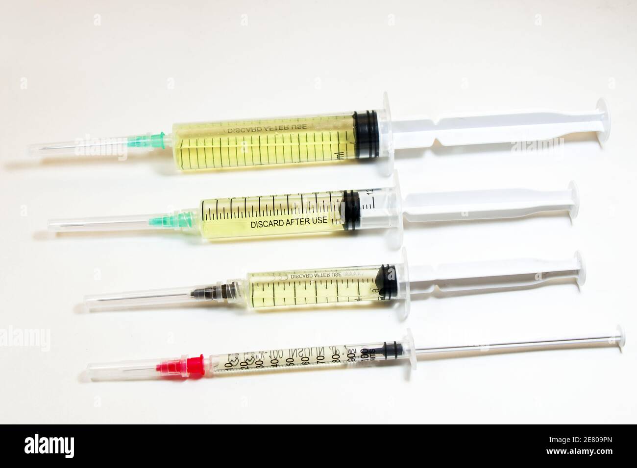Isolated shot of some medical syringes of different sizes on the ...