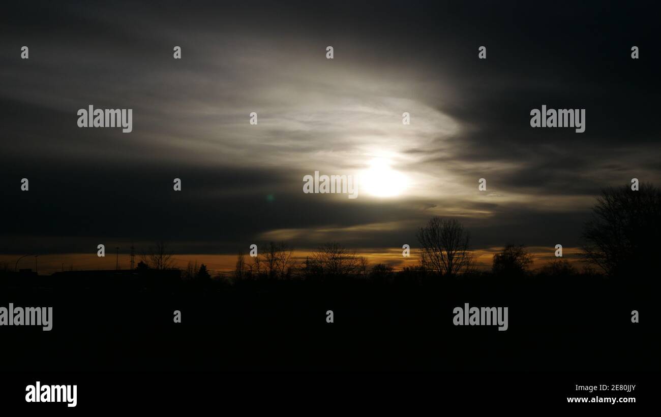 Gloomy sunset in the rural field with clouds and smear sun Stock Photo ...