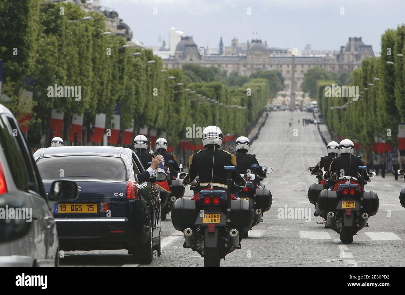 President Jacques Chirac waves the crowd as he leaves his last ceremony ...